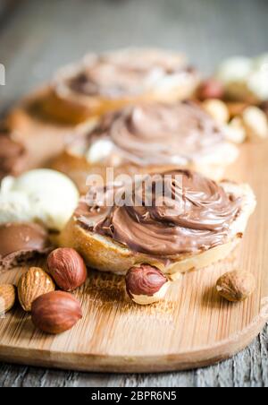 Slices of bread with hazelnut cream with nuts on plate closeup Stock ...