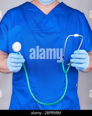 doctor in blue uniform and latex gloves is holding an empty plastic ...