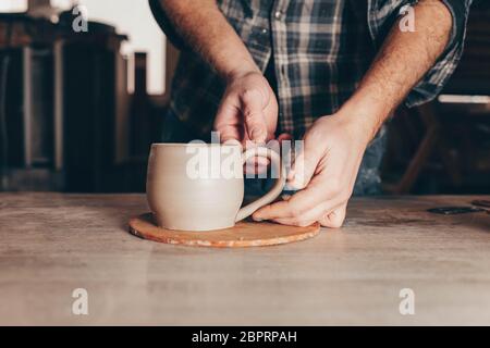 Potter works on a ceramic cup Stock Photo - Alamy