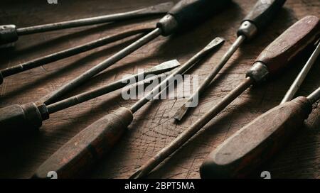 Set of old vintage screwdrivers with worn wooden handles standing ...