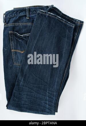 folded blue men's jeans on a white background, top view Stock Photo - Alamy