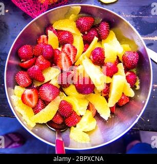 festive fruit colors: mix of peeled orange and ripe strawberries in ...