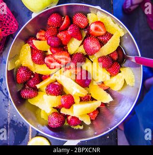 festive fruit colors: mix of peeled orange and ripe strawberries in ...