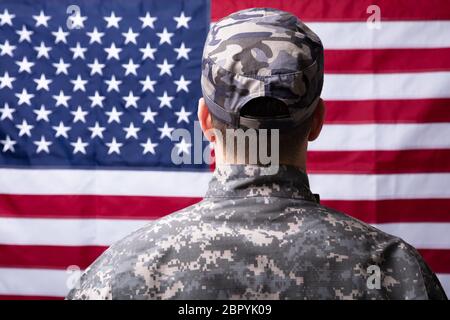 Front view of serious professional soldier with modern weapons machine ...