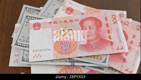 Counting with chinese RMB and USD banknote Stock Photo - Alamy