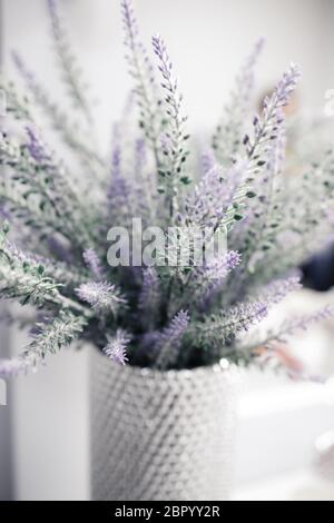 Vase with blossoming branches on table near color wall Stock Photo - Alamy