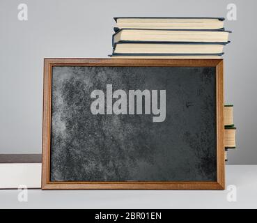 black chalk drawing frame and stack of books, gray background , back to ...
