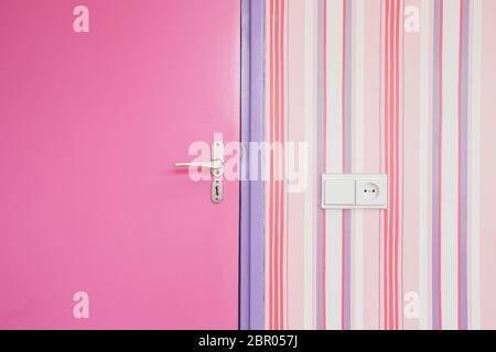 pink door with pink striped wallpaper closeup, girly design interior ...