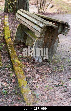 An old broken wooden bench in a park Stock Photo - Alamy