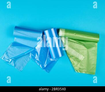 Blue rolls of garbage bin bags isolated on white background with copy ...