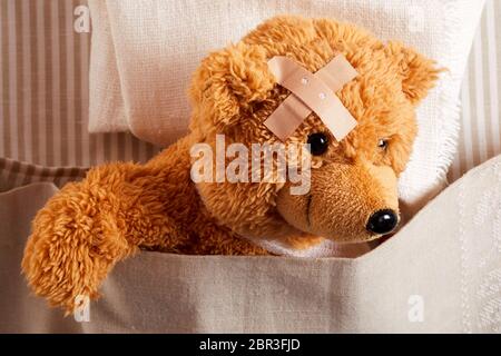 Paediatric healthcare concept with a little teddy bear with its arm in ...