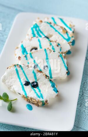 Sliced merengue roll with nuts Stock Photo - Alamy
