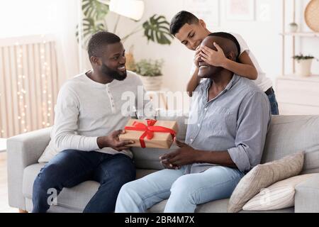 Affectionate Little Boy And His Father Surprising Happy Granddad With ...
