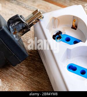 burnt power strip electrocution danger vertical Stock Photo - Alamy