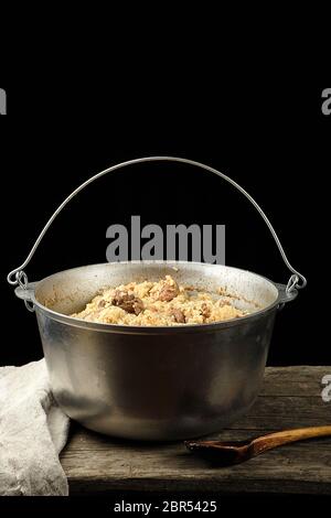 Rice pilaf in a large pan isolated on black. Top view Stock Photo - Alamy