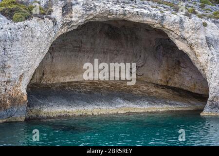 Stone arch entrance to one of the many Blue Caves in Zante Island ...