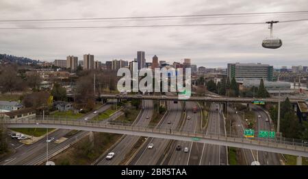 The cable car is full of riders exploring Portland via aerial ...
