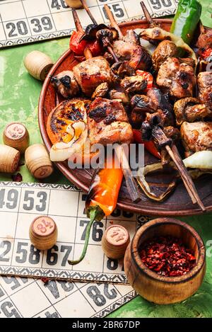 Summer picnic with shashlik and lotto board game.Barbecue and board ...