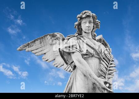 Statue of an angel with olive branches with sky and clouds in the ...