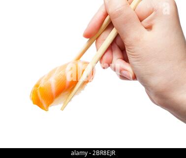 female hand with disposable chopsticks holds sake nigiri sushi with salmon fish isolated on ...