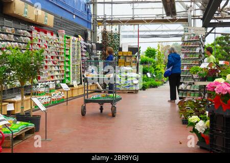 People looking at garden centre plant plants on display at the Spring ...