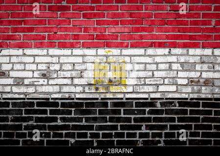 National flag of Egypt depicting in paint colors on an old brick wall ...