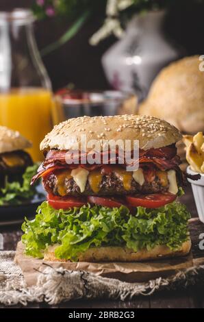 Homemade bacon burger with lettuce and cheddar, homemade potato french ...