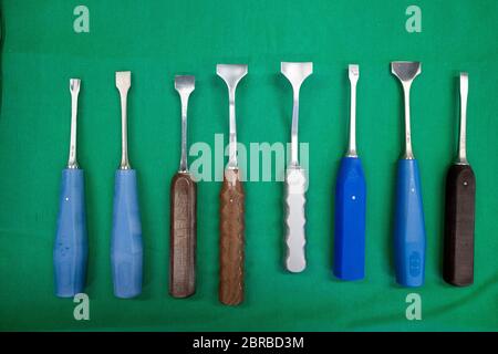 different surgical chisels lie side by side on a surgical drape Stock ...