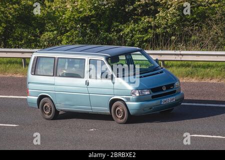 Blue MPV car side view isolated on white background Stock Photo - Alamy