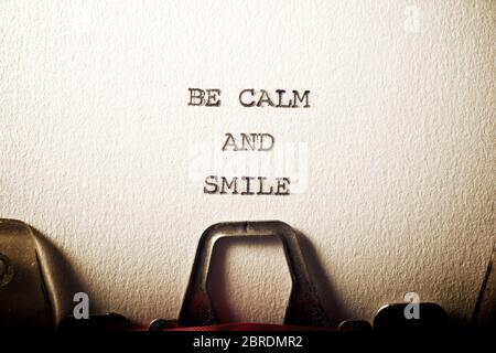 Be calm and smile text written with a typewriter Stock Photo - Alamy