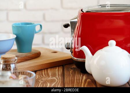 Ceramic teapot and toaster, kitchen table close up Stock Photo - Alamy