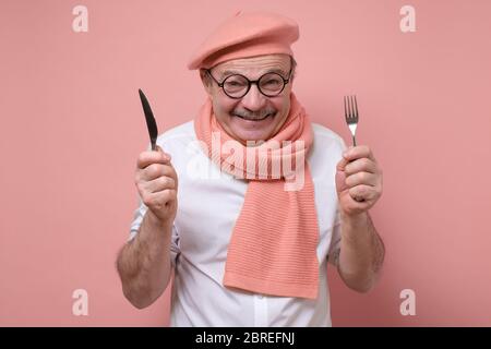 Hand of hispanic man holding funny piggy bank with glasses over ...