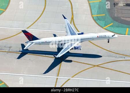 Delta Airlines Boeing 757 at LAX airport connected to jet bridge aerial ...
