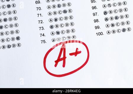 Final exam marked with A+ with red pencil Stock Photo - Alamy