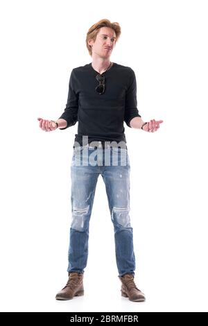 Bored young man looking indifferent and tired at camera, listening ...