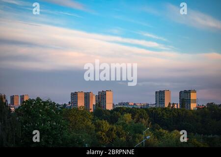 Sunrise - Cloudy sky above blocks, concrete buildings residential area ...