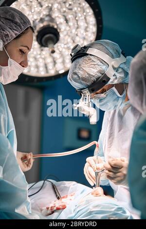 Plastic surgeons operating patient in clinic Stock Photo - Alamy