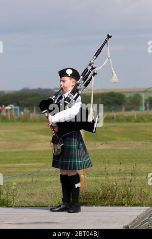 Scottish Bagpipe player in traditional costume (Tartan of Cameron of ...
