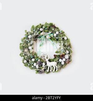 Christmas wreath with cones, balls, sprinkled with artificial snow ...