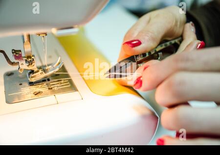 Cutting the thread after sewing, Cutting the thread after sewing Stock ...