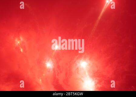 Football fans burning red flares and creating thick smoke at a soccer ...