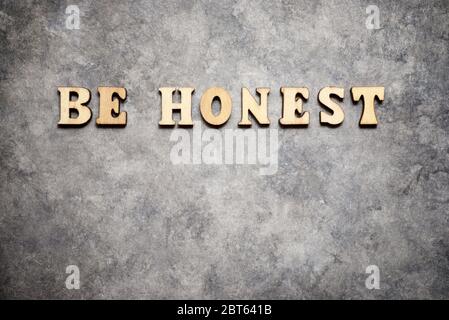 Be honest text on a gray paper Stock Photo - Alamy
