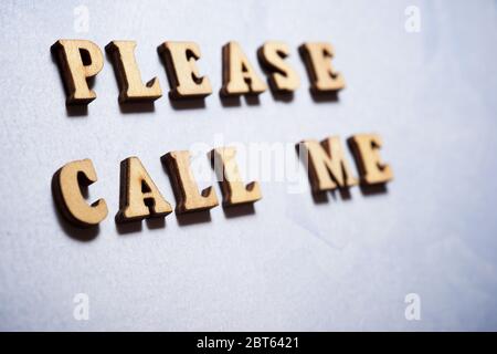 Call me Please text in a colored paper Stock Photo - Alamy