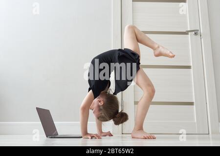 Little girl doing backbend gymnastics exercise at home Stock Photo - Alamy