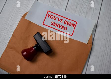 Red Handle Rubber Stamper and You've Been Served text above brown ...
