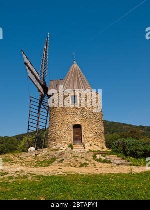 Grimaud a medieval village at the top of a hill from Massif des Maures ...