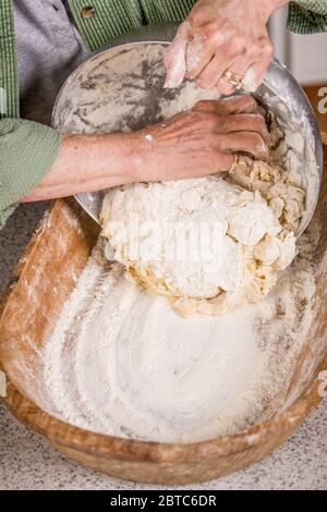 person kneading dough on wooden table Stock Photo - Alamy