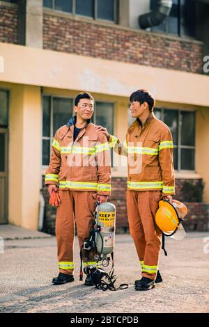 Asian male and female firefighter portrait, young smiling fireman in ...