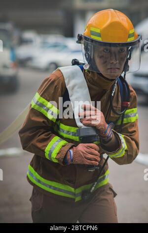 Asian male and female firefighter portrait, young smiling fireman in ...