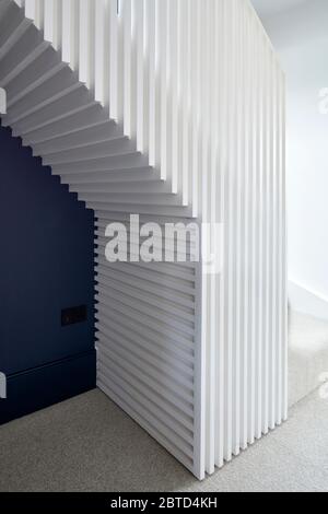 White staircase with ribbed wooden slat design. Long House, London ...